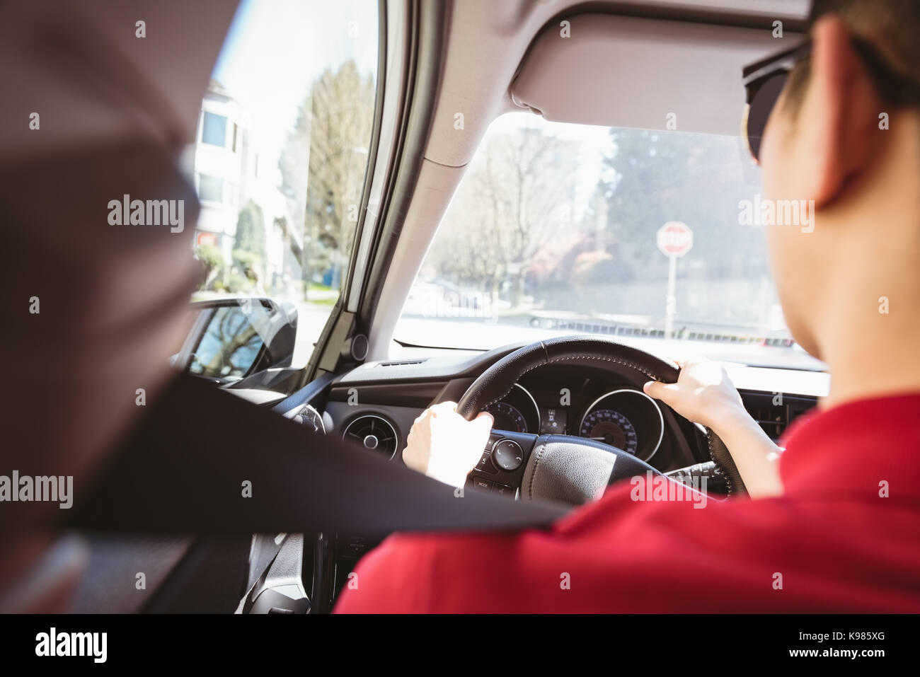 Rear view of man driving a car Stock Photo - Alamy