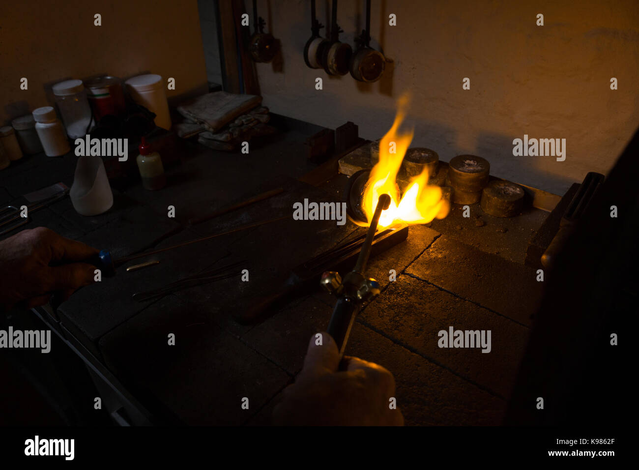 Close-up of goldsmith hands using welding torch in workshop Stock Photo ...