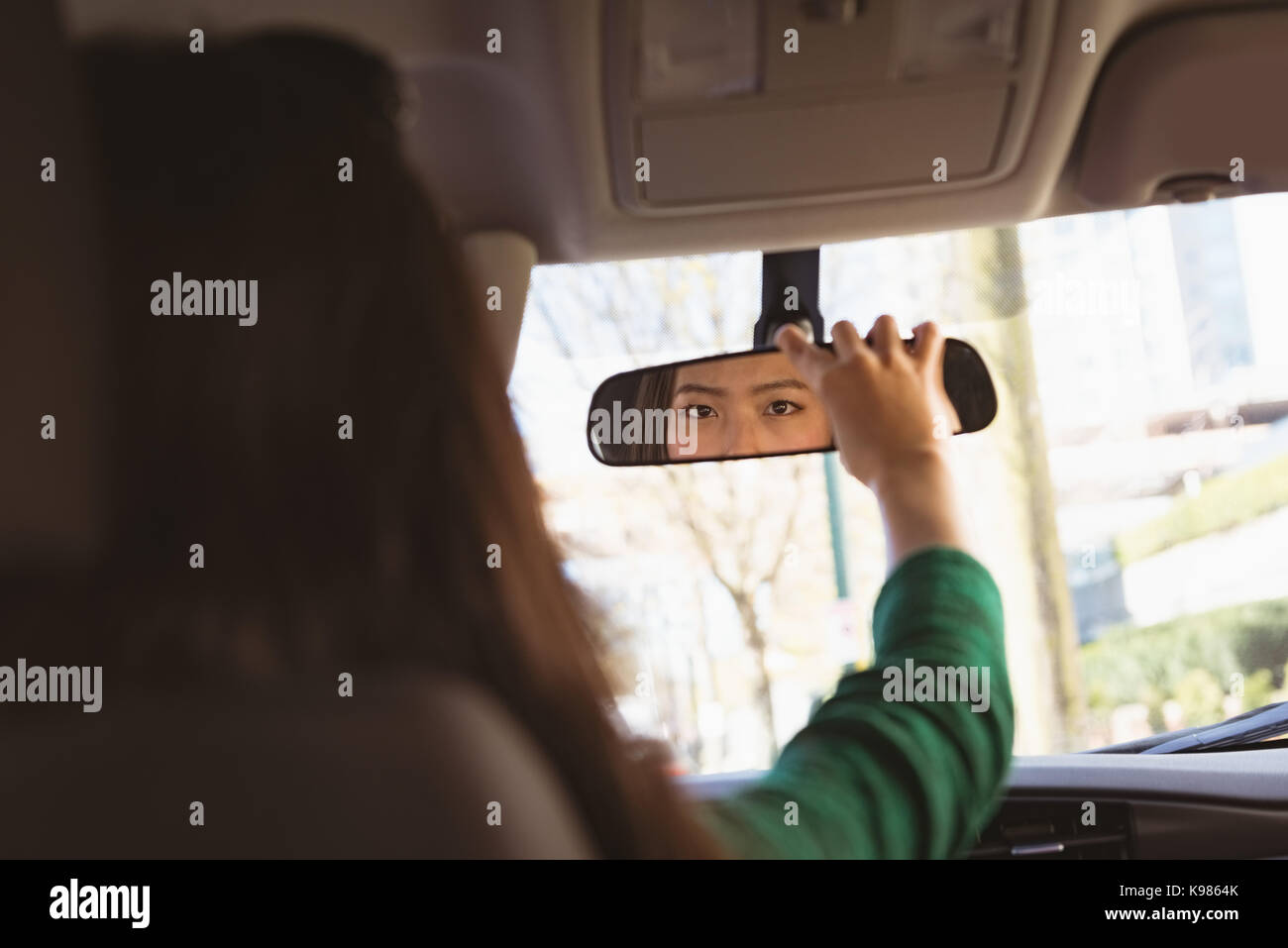Reflection happy young woman rear view mirror car hi-res stock ...