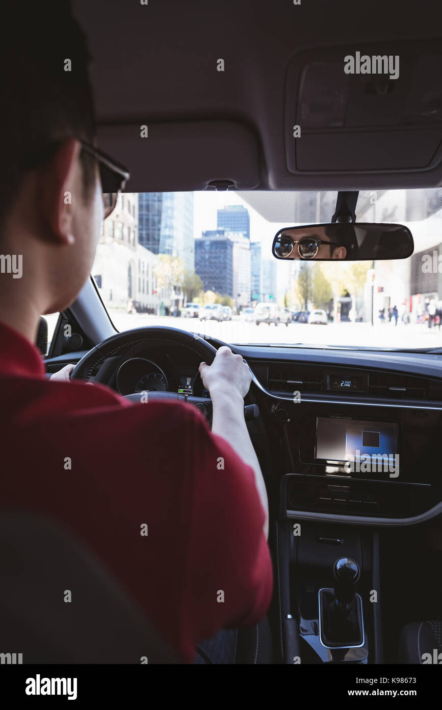 Rear view of man driving a car Stock Photo - Alamy