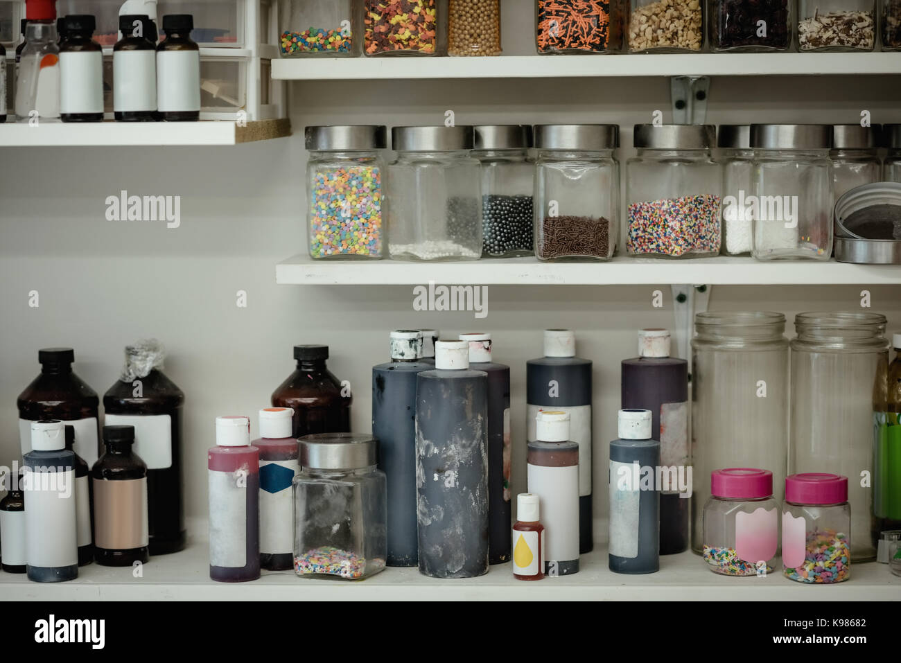 Various ingredient bottles kept in shelf at kitchen Stock Photo - Alamy