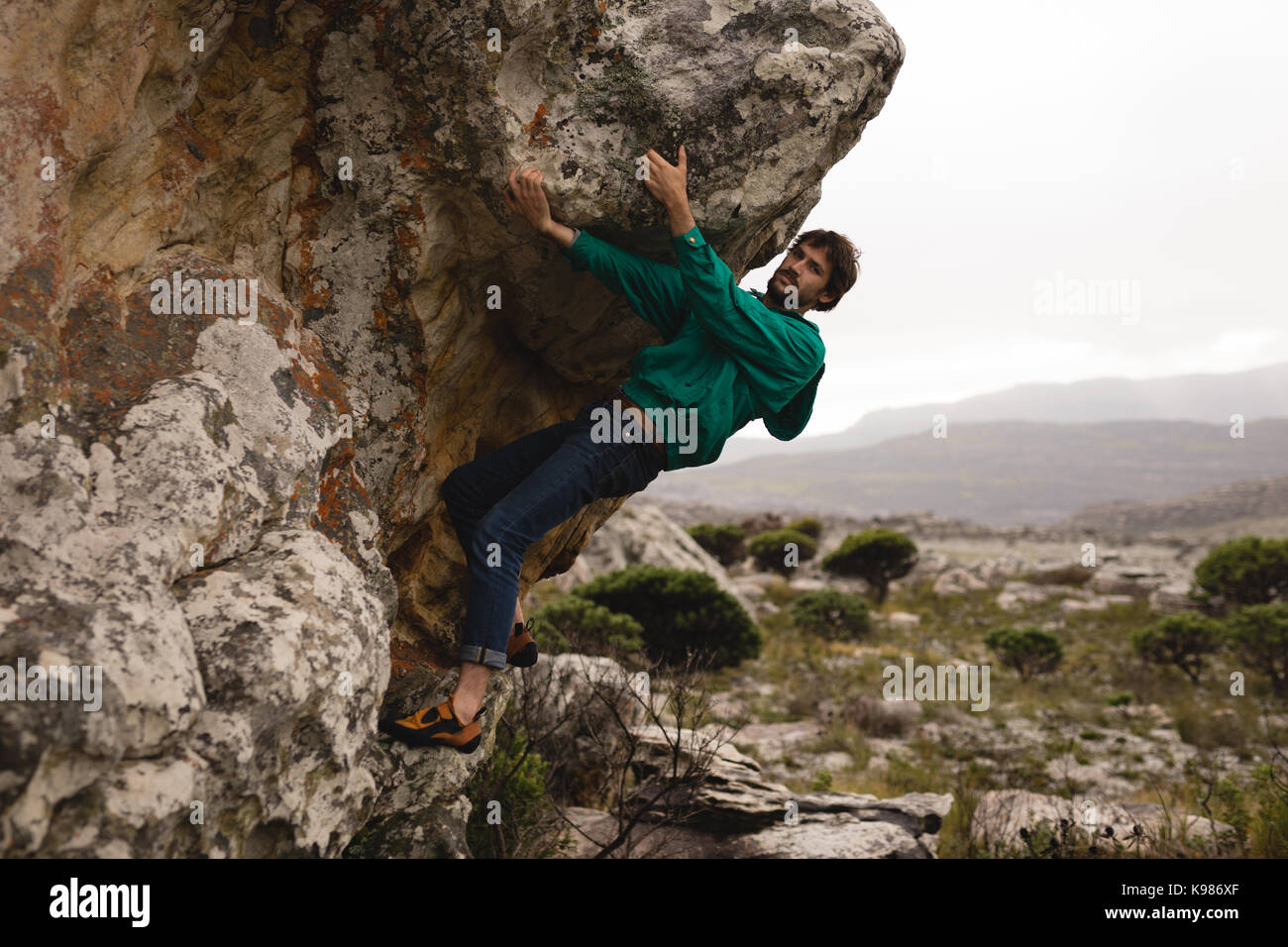 Man climbing mountain on a sunny day Stock Photo - Alamy