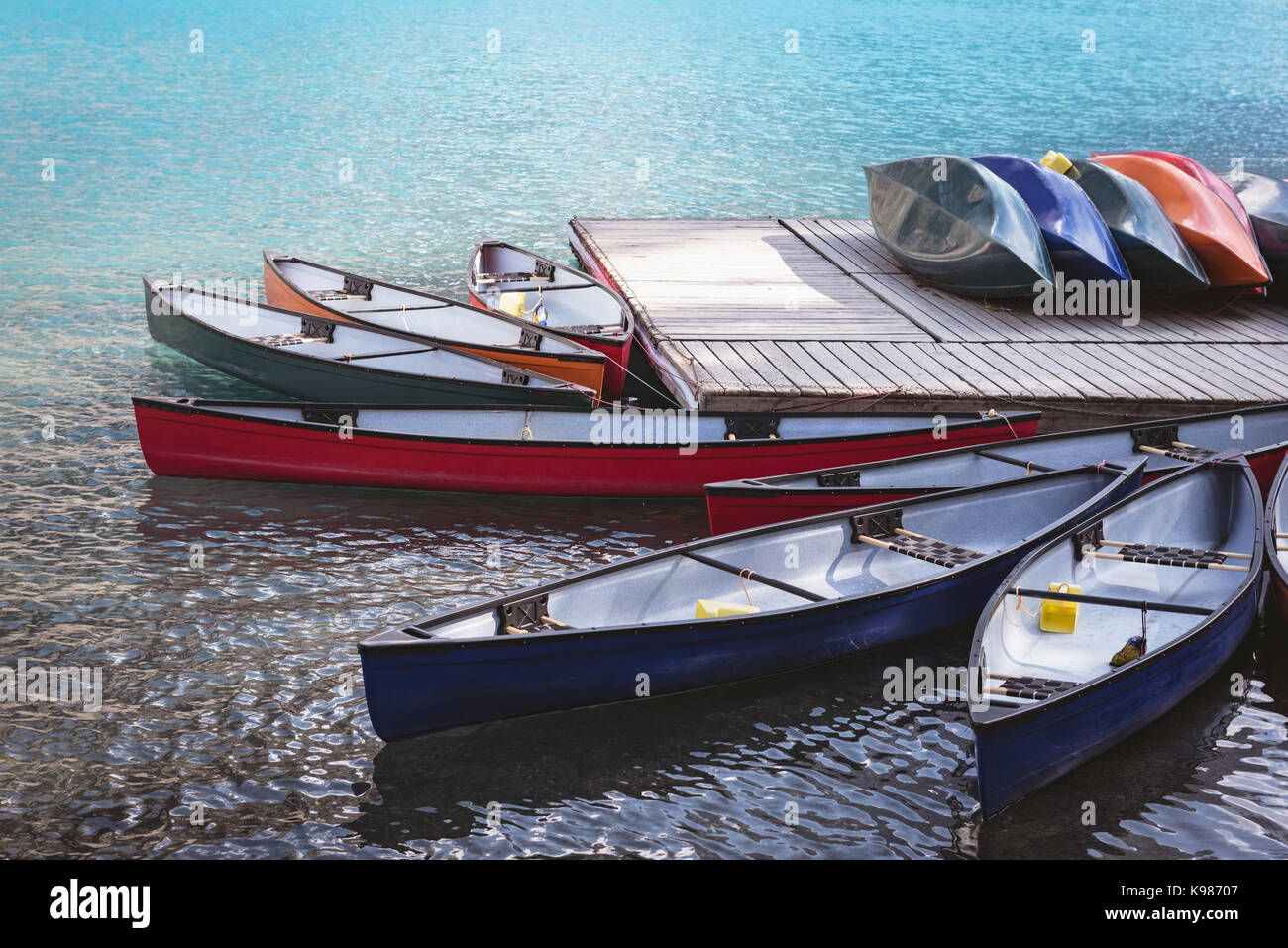 Empty boats arranged on pier near lake Stock Photo - Alamy