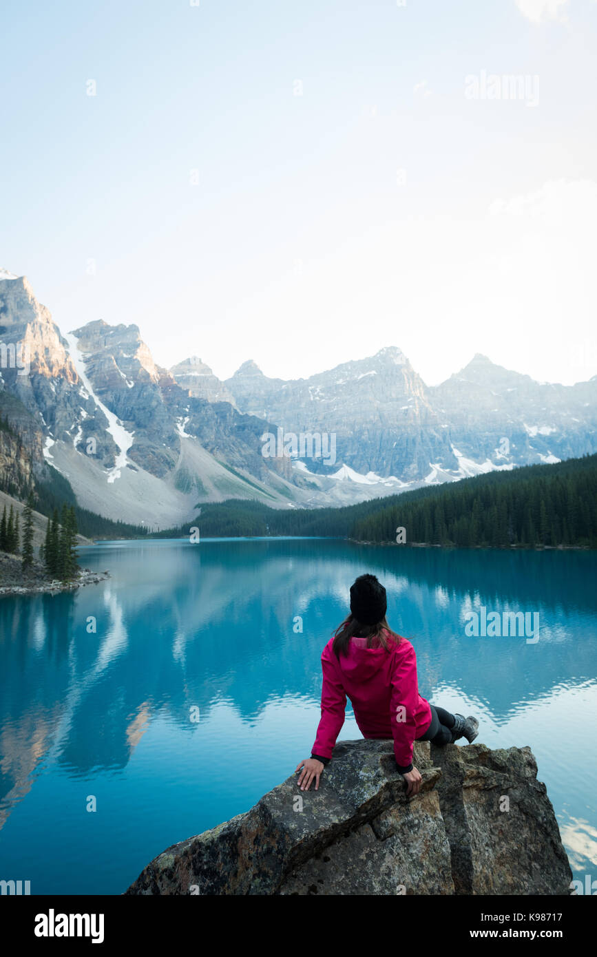 Woman sitting near lake side on a sunny day Stock Photo - Alamy
