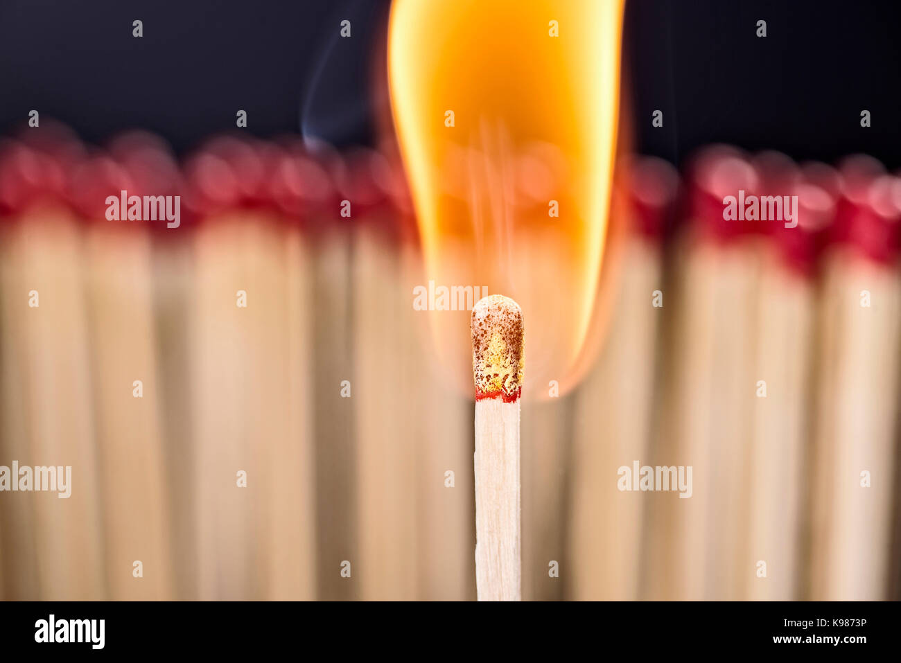 Burning matchstick in front of a new set of matches Stock Photo - Alamy