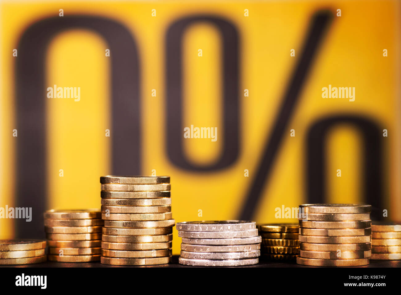Coins with the symbol for 0% interest in the background Stock Photo - Alamy