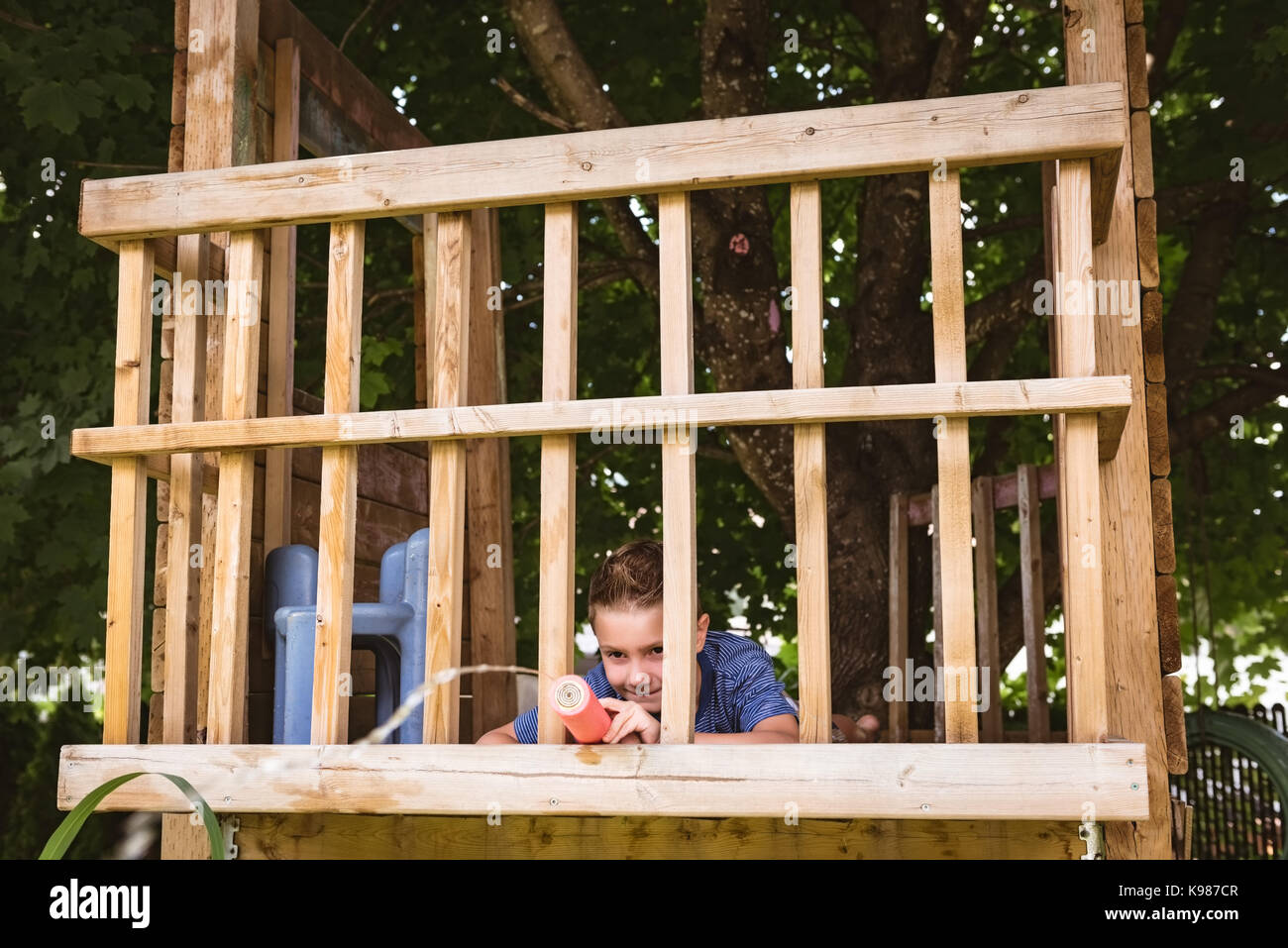 Cute boy playing with water gun in playground Stock Photo - Alamy