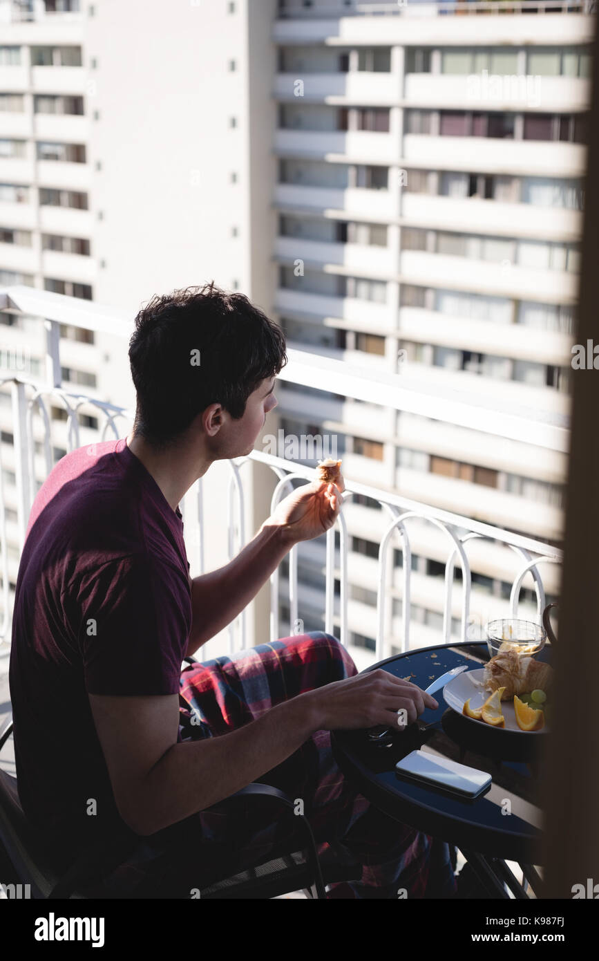 Man having breakfast in balcony at home Stock Photo - Alamy