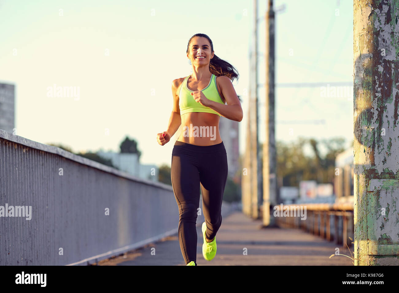 Woman running bridge through city hi-res stock photography and images ...