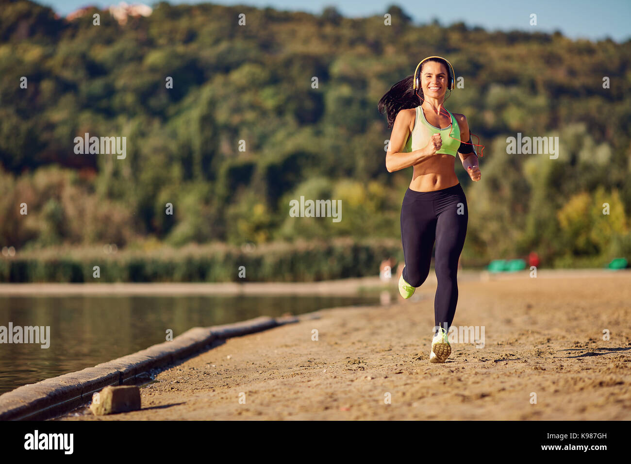 A sports girl runs through the park Stock Photo - Alamy