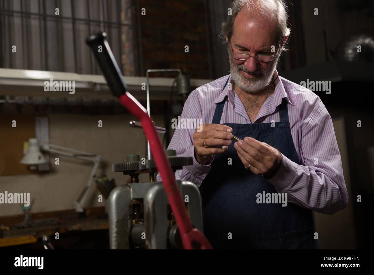 Senior goldsmith working in workshop Stock Photo - Alamy