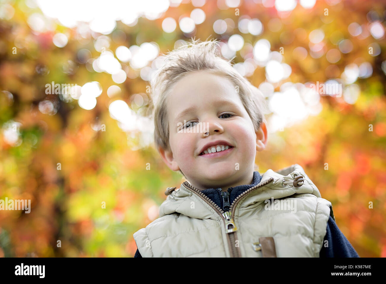 A boy in autumn season in a park Stock Photo - Alamy