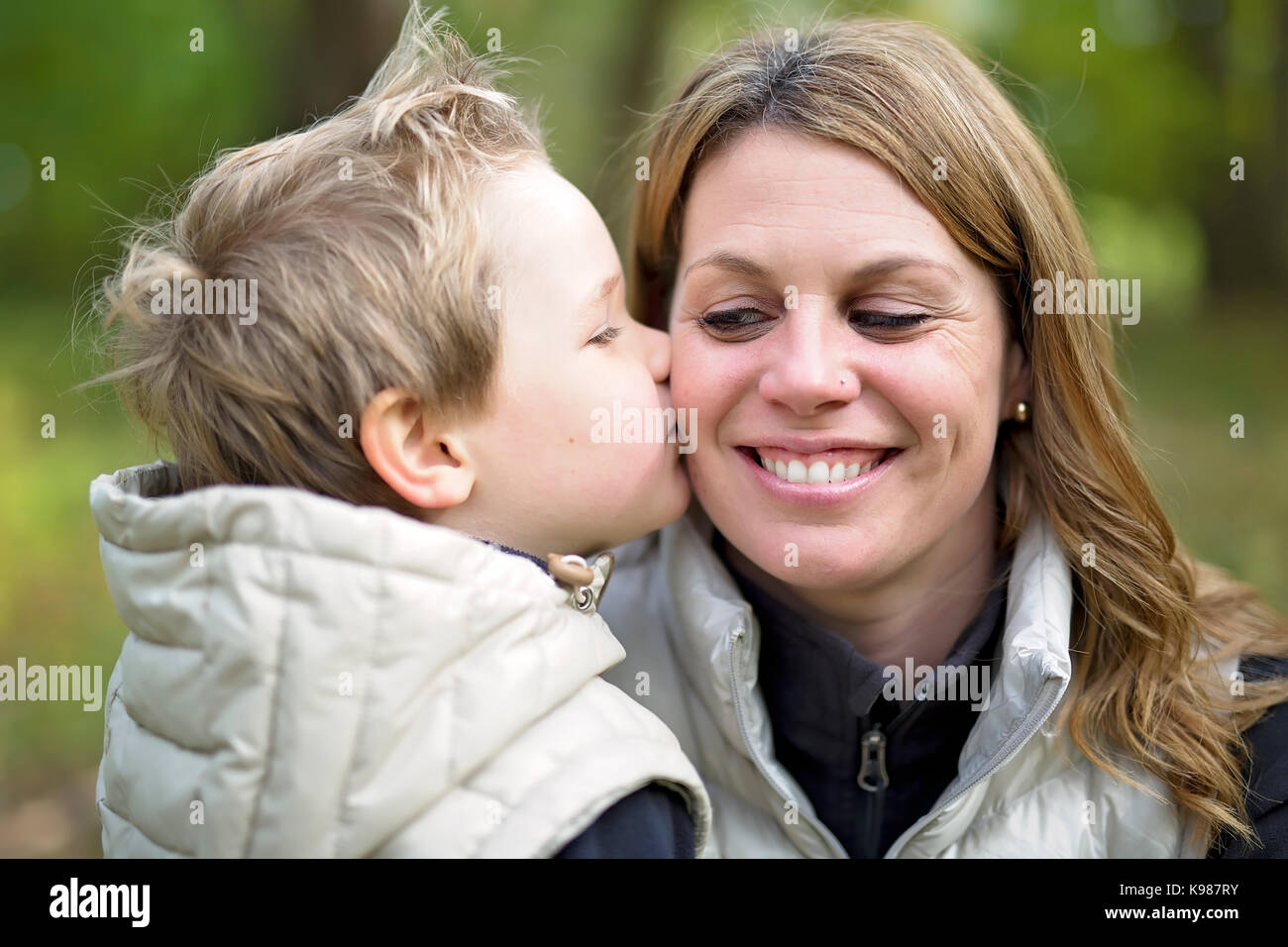 An Adorable little boy with his mother in autumn park Stock Photo - Alamy