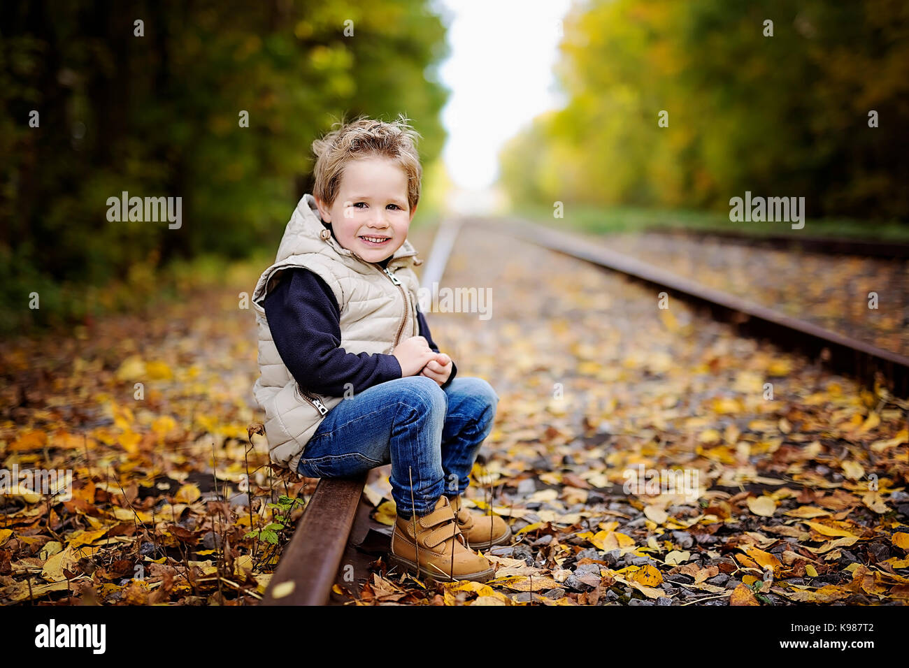 A boy in autumn season in a park Stock Photo - Alamy
