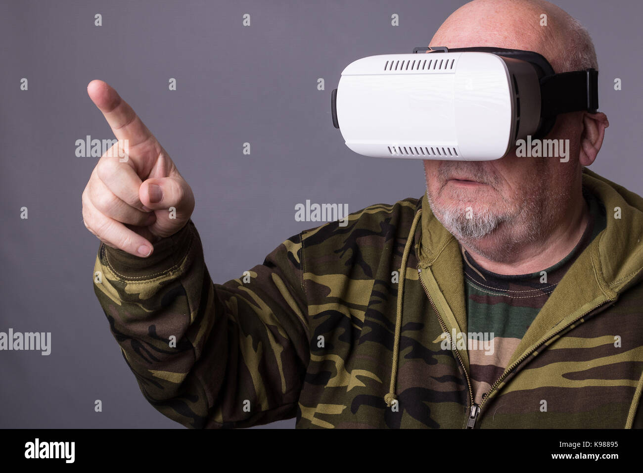 Senior man in wearable technology VR glasses. Confident old man wearing ...