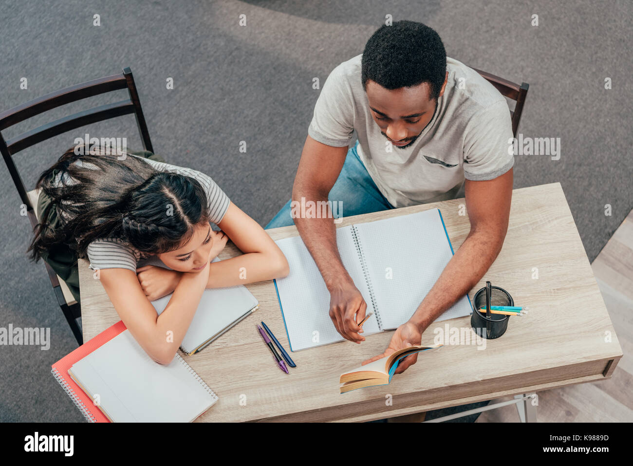 Happy friends doing homework together hi-res stock photography and ...