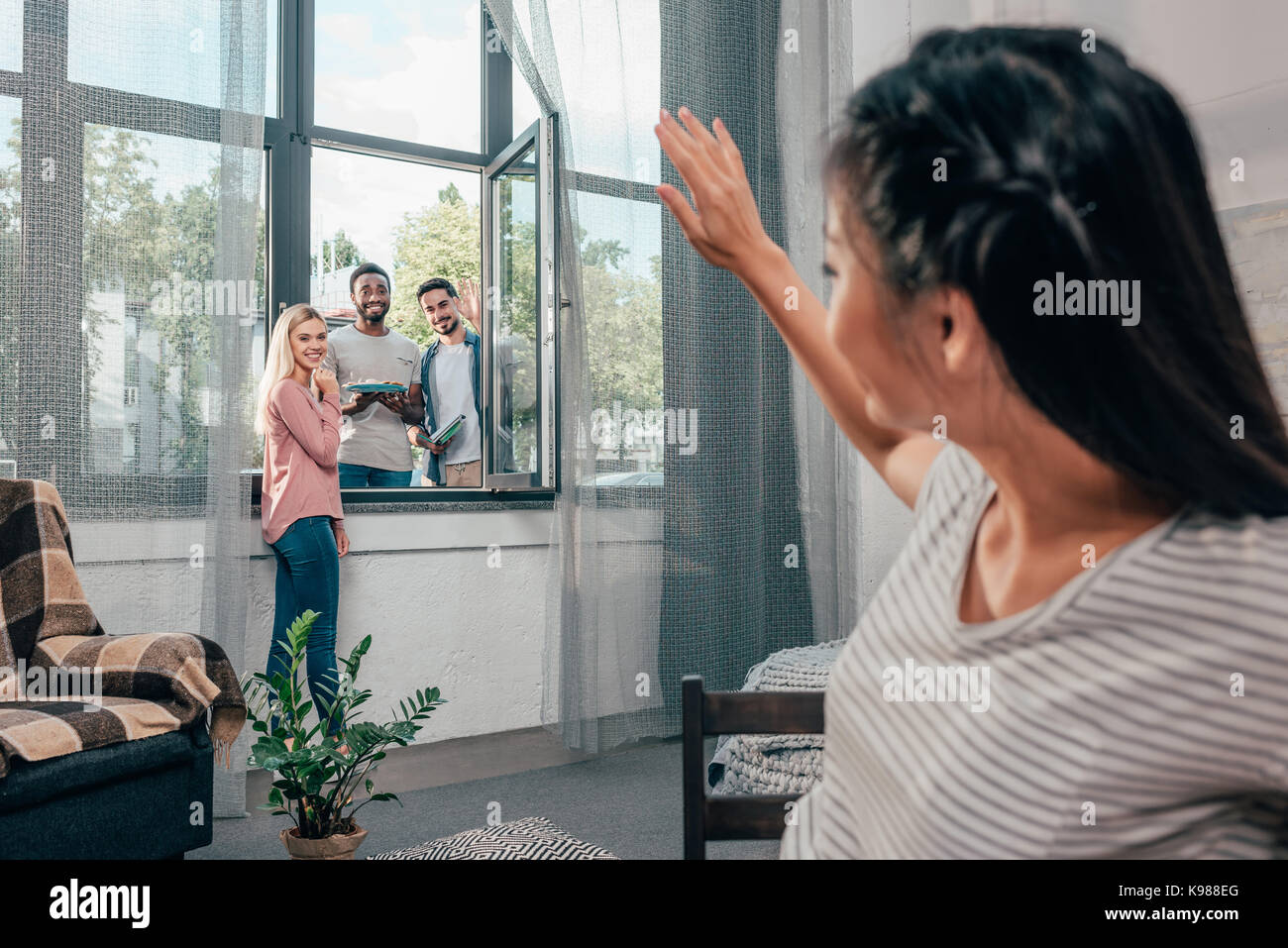 Woman waving at group of people hi-res stock photography and images - Alamy