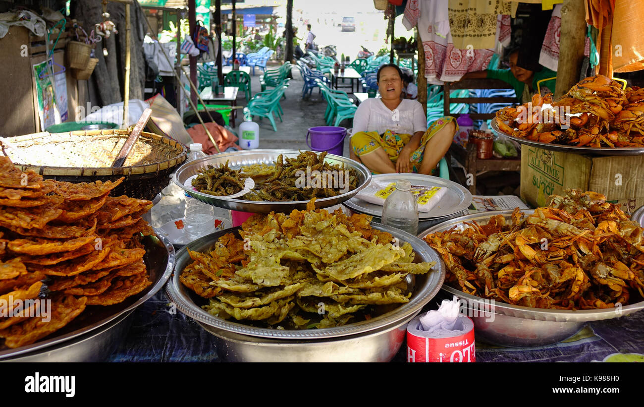 Yangon, Myanmar - Feb 11, 2017. A vendor selling foods on street in ...