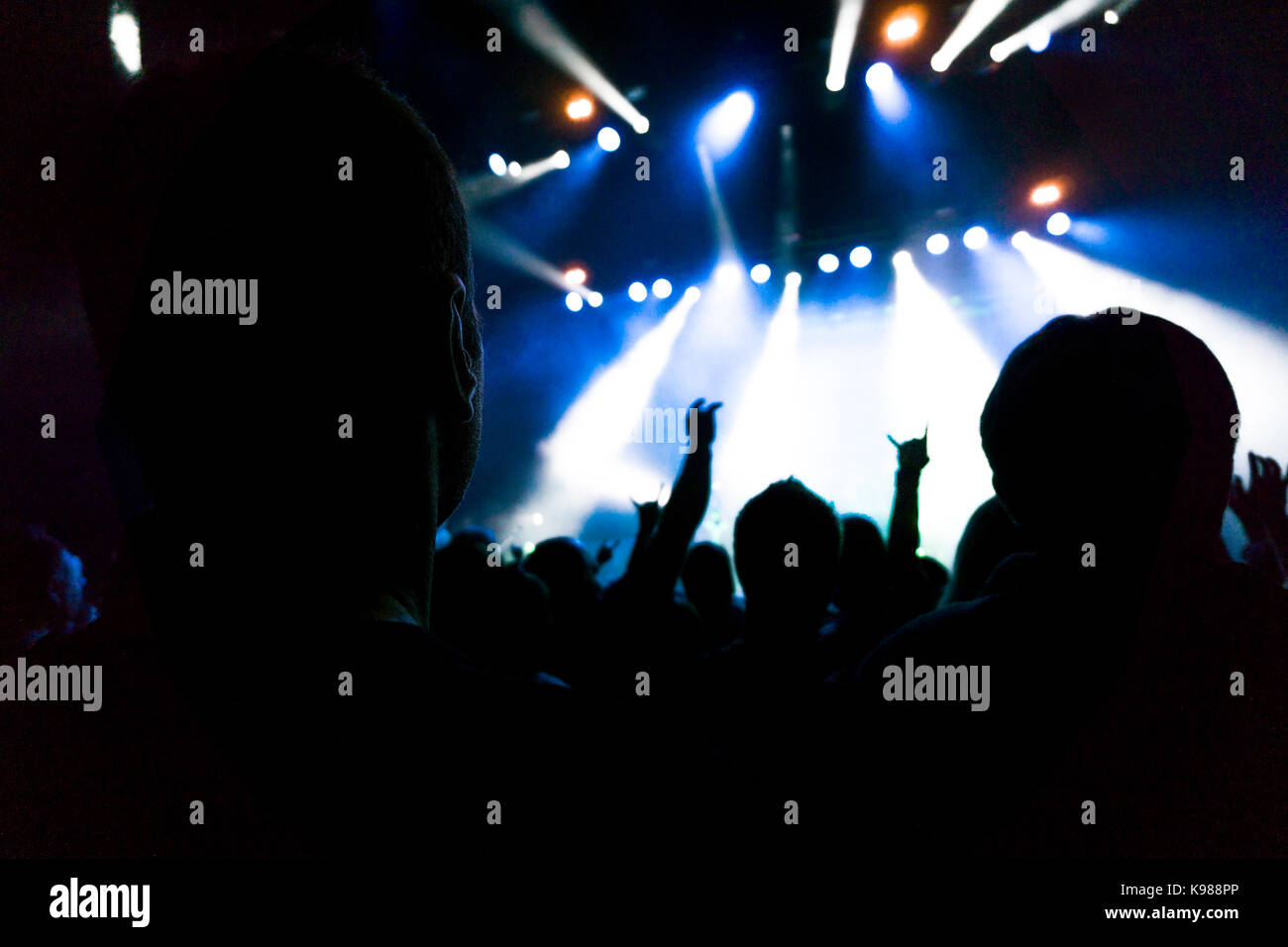 a crowd shadow of people at during a concert Stock Photo - Alamy