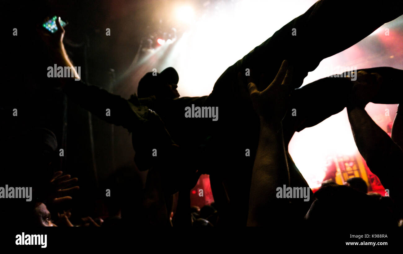 a crowd shadow of people at during a concert Stock Photo - Alamy