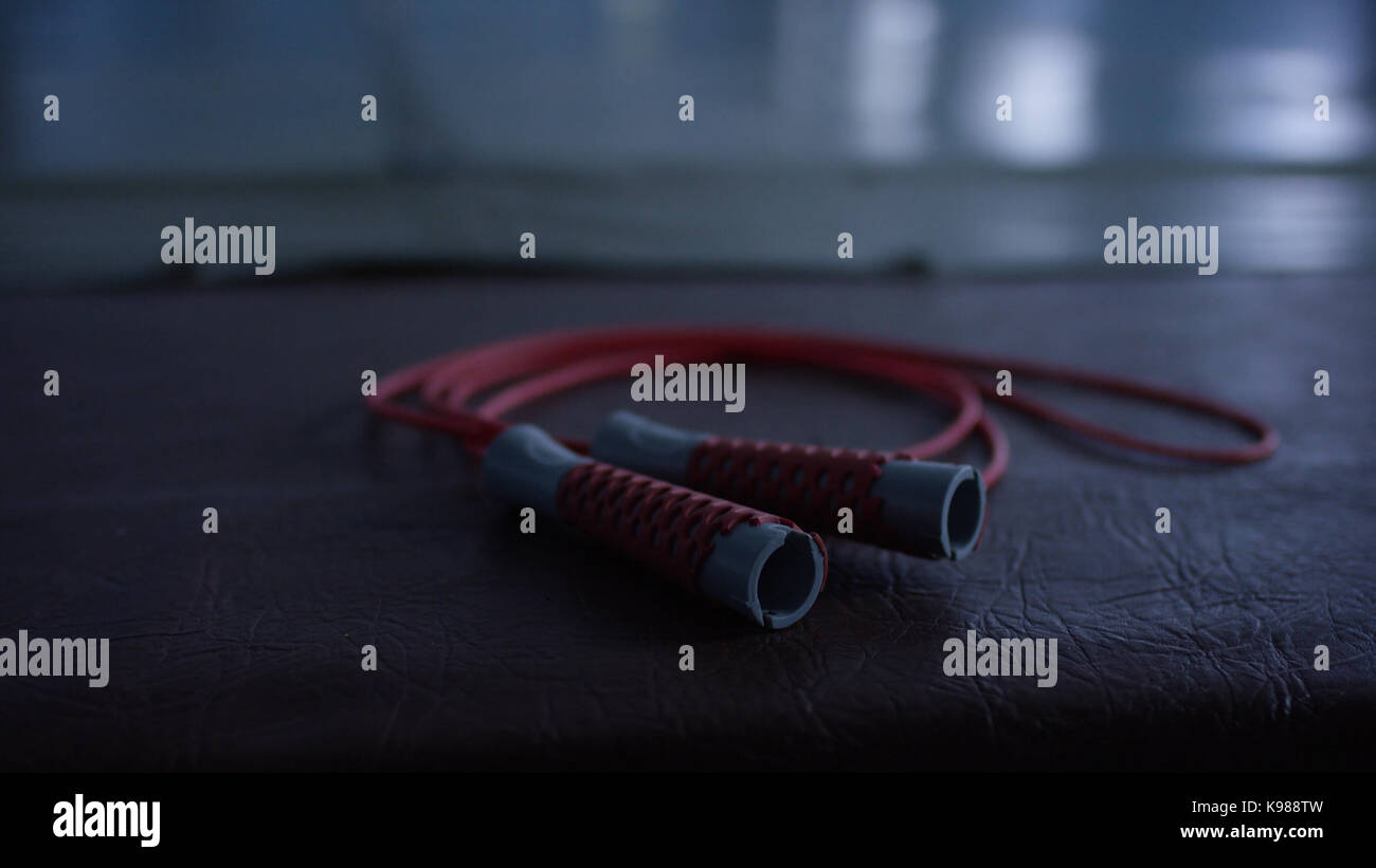 Jump rope lying on the floor, closeup Stock Photo - Alamy