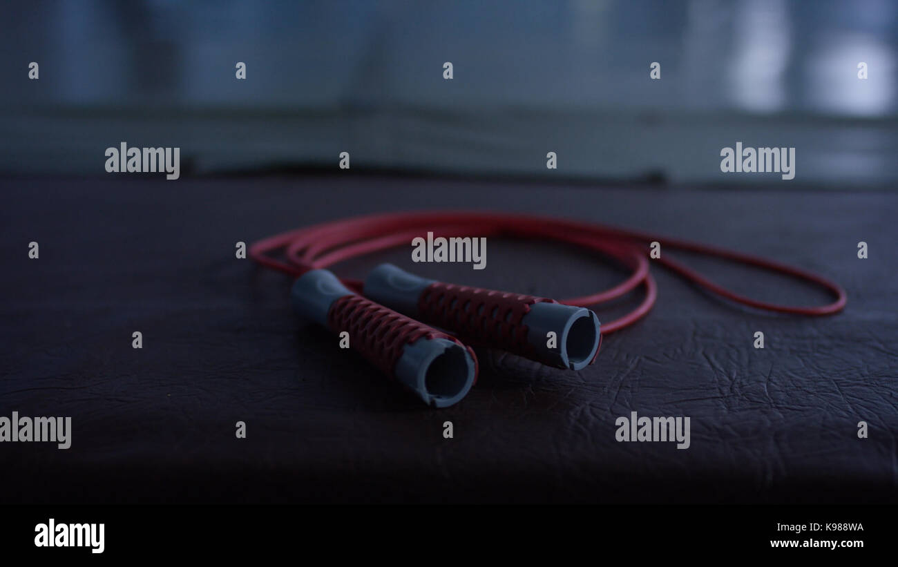 Jump rope lying on the floor, closeup Stock Photo - Alamy