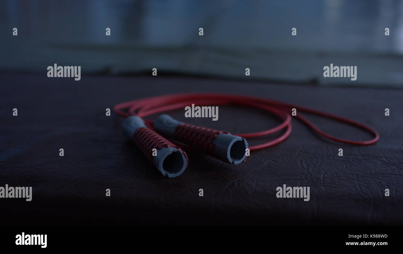 Jump rope lying on the floor, closeup Stock Photo - Alamy