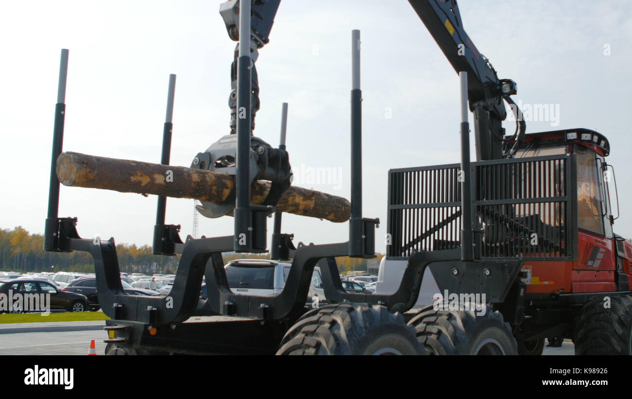 Log loader or forestry machine moves fresh cut logs for loading Stock ...