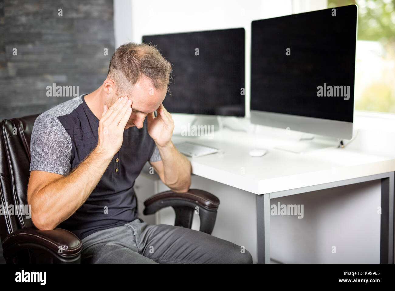 A Young business man with problems and stress in the office Stock Photo ...