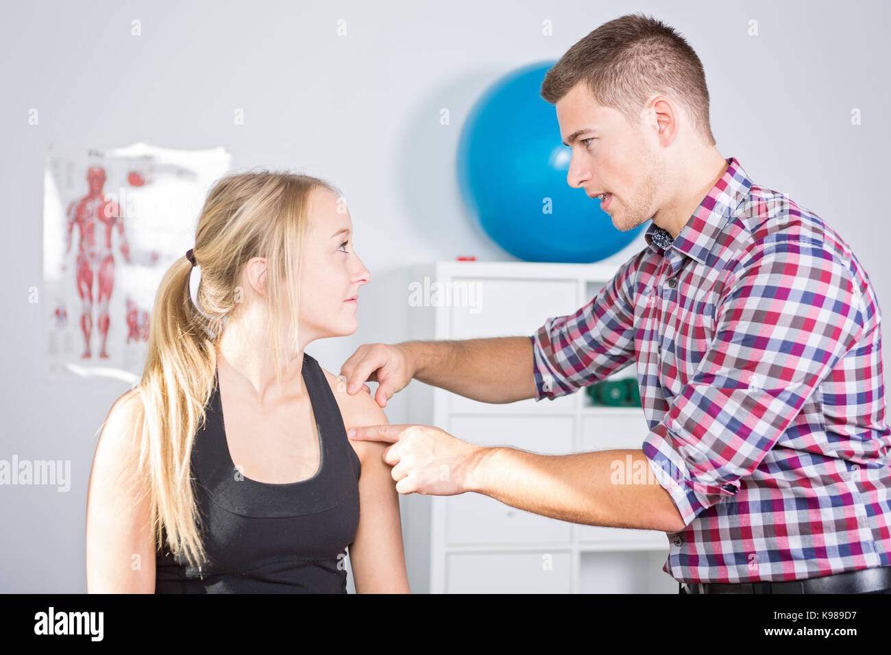A male physio therapist and woman helping patient Stock Photo - Alamy
