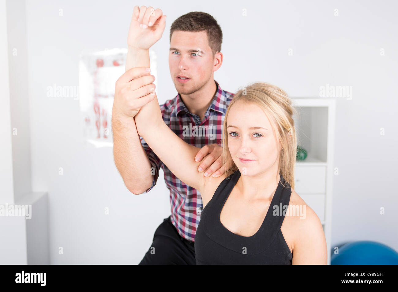 A male physio therapist and woman helping patient Stock Photo - Alamy