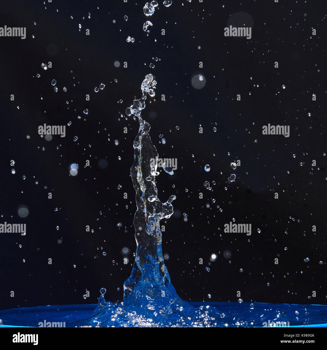 Blue water drops falling down Stock Photo - Alamy