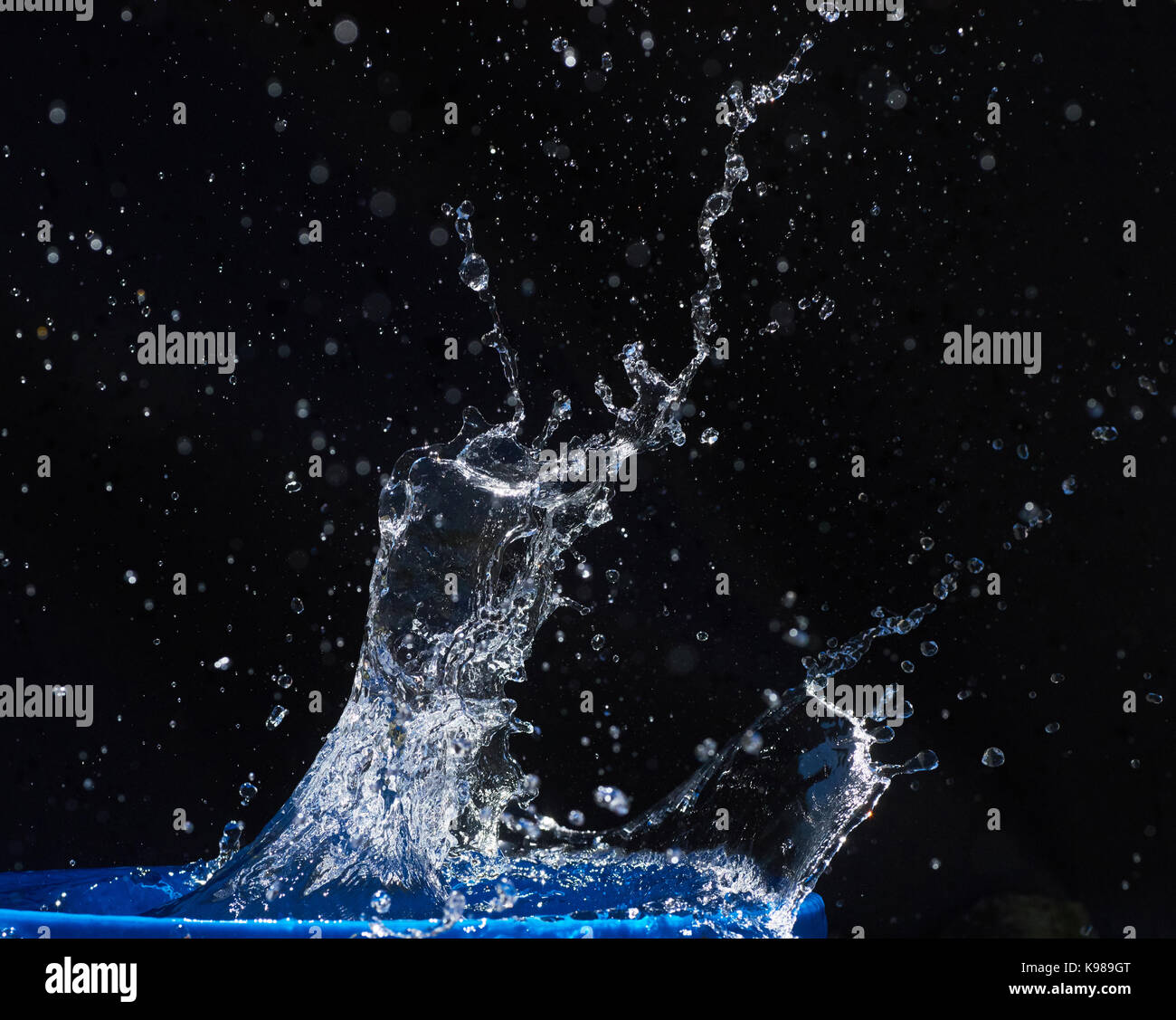Blue water drops falling down Stock Photo - Alamy