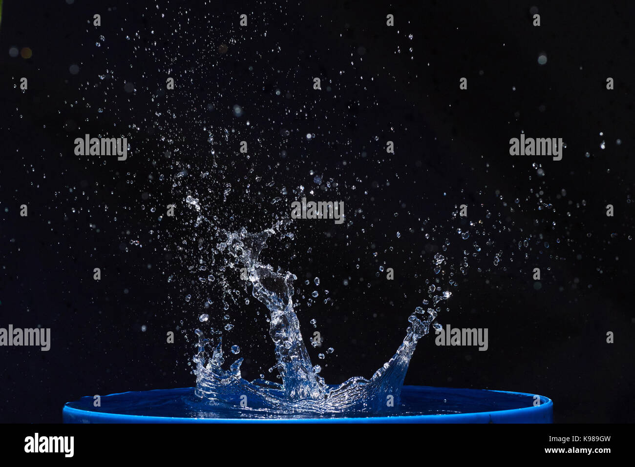 Blue water drops falling down Stock Photo - Alamy
