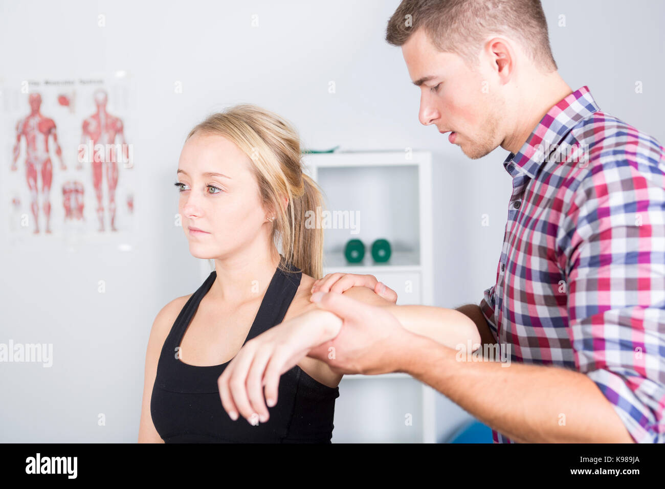 A male physio therapist and woman helping patient Stock Photo - Alamy