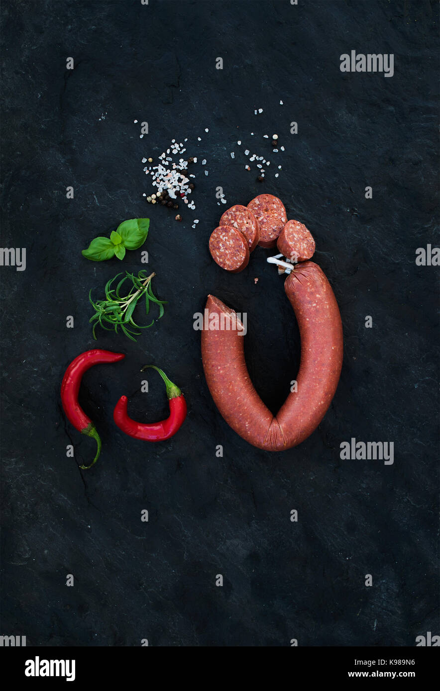 Smoked salami sausage with rosemary, chili pepper, basil and salt over ...