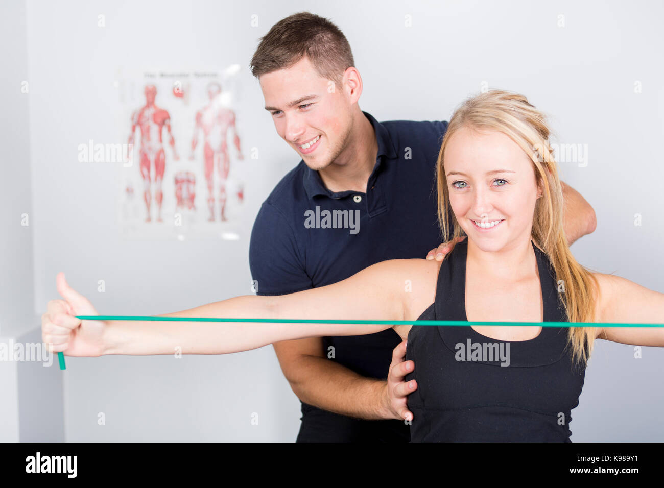 A male physio therapist and woman helping patient Stock Photo - Alamy