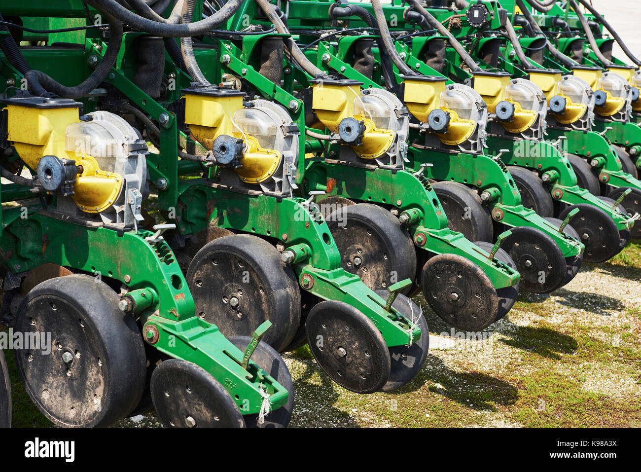 Close up of seeder attached to tractor in field. Agricultural machinery ...