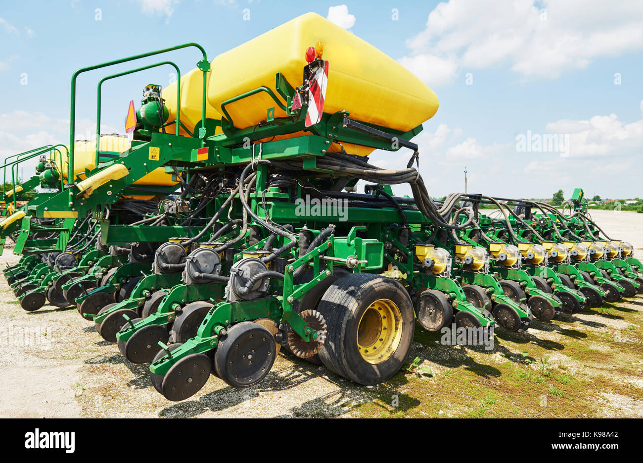 Close up of seeder attached to tractor in field. Agricultural machinery ...