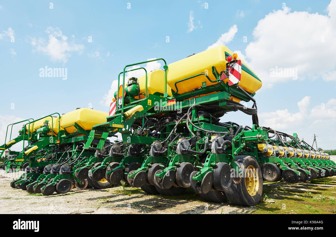 Close up of seeder attached to tractor in field. Agricultural machinery ...