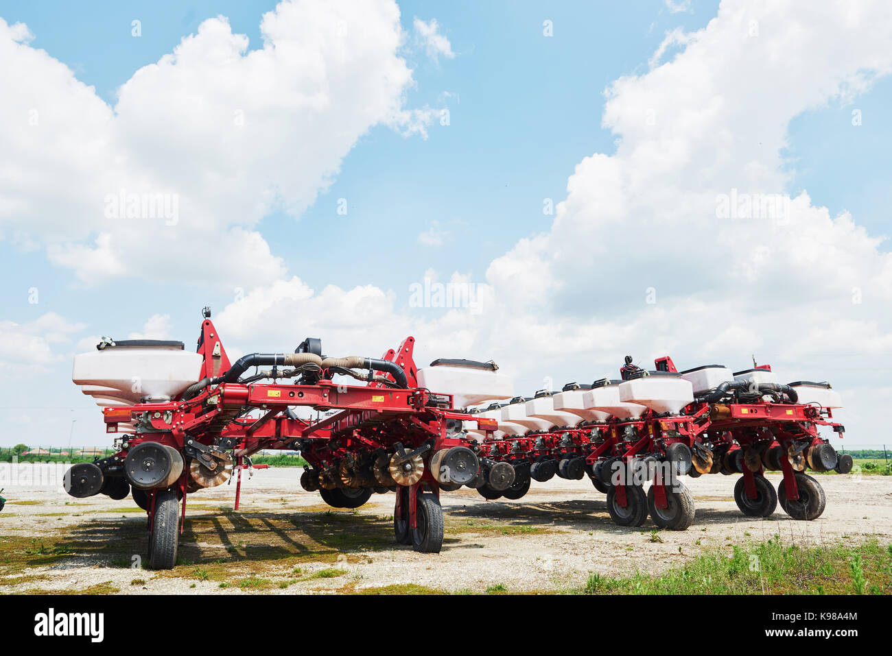 Close up of seeder attached to tractor in field. Agricultural machinery ...