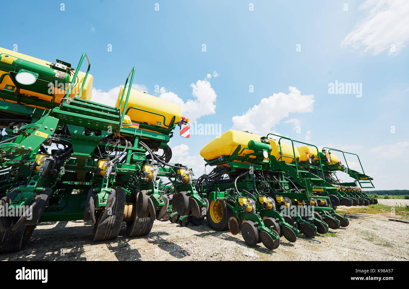Close up of seeder attached to tractor in field. Agricultural machinery ...