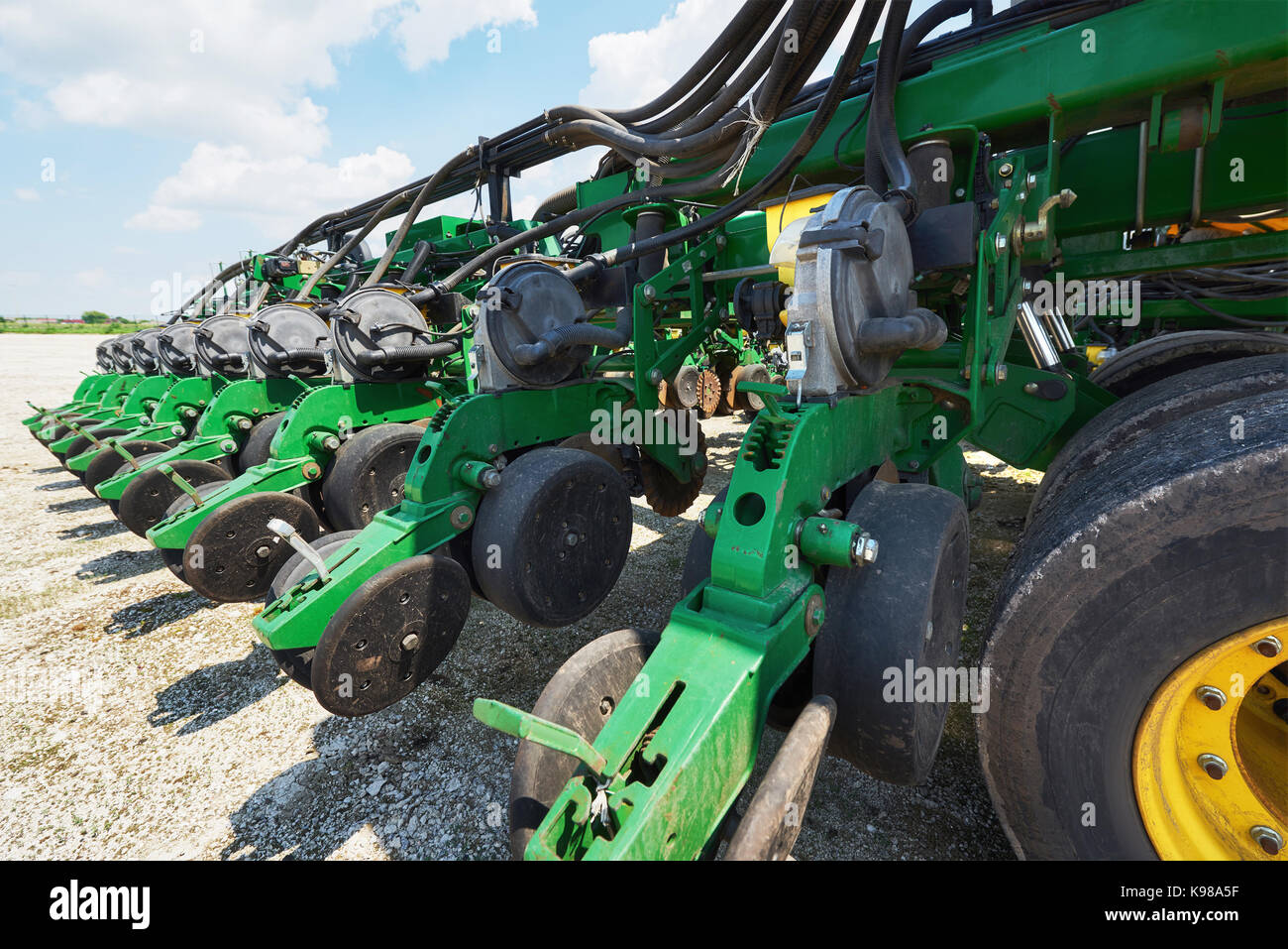 Close up of seeder attached to tractor in field. Agricultural machinery ...