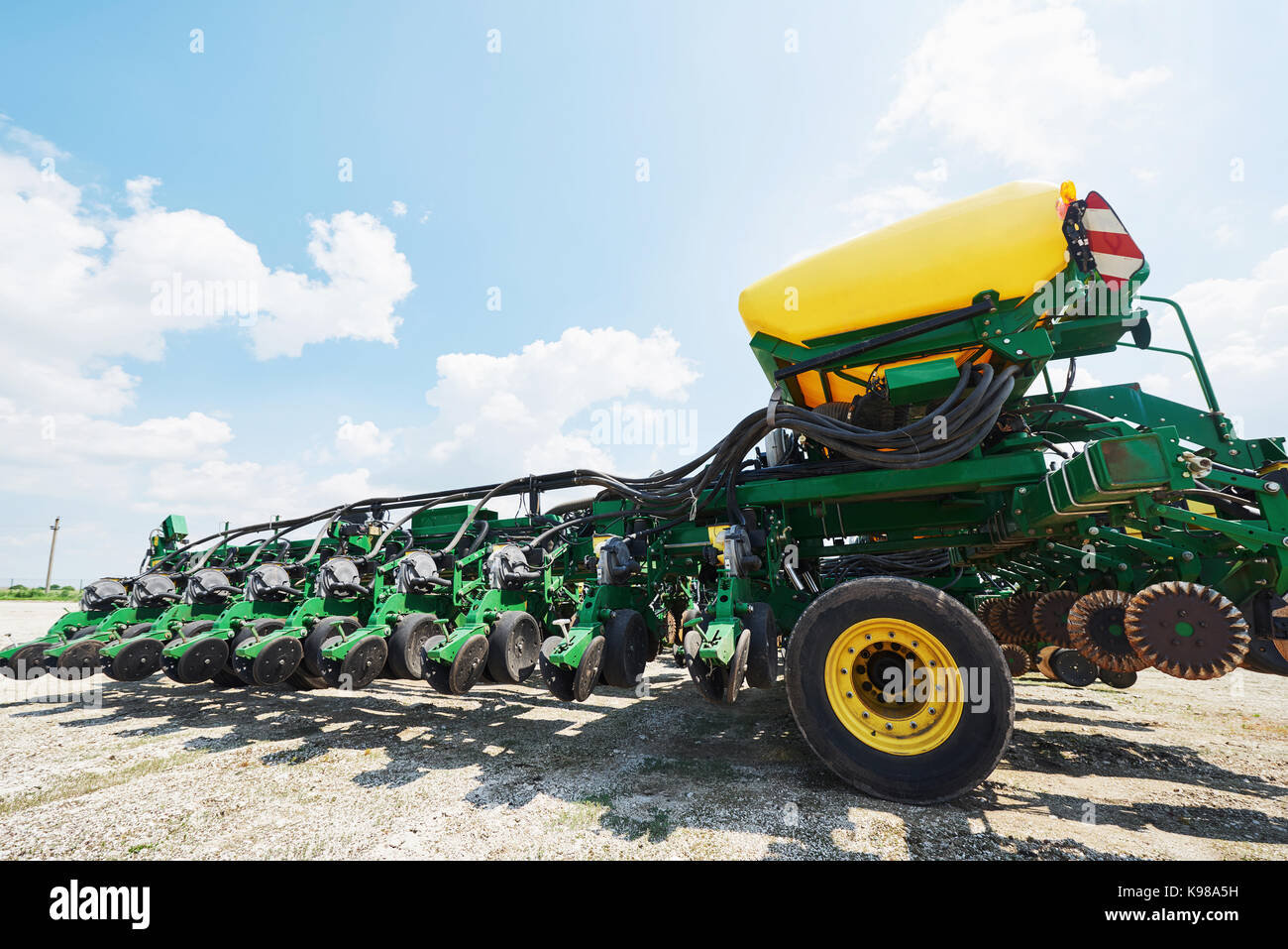 Close up of seeder attached to tractor in field. Agricultural machinery ...