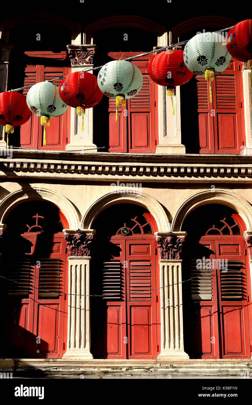 Traditional shop house exteriors with wooden louvered shutters and ...