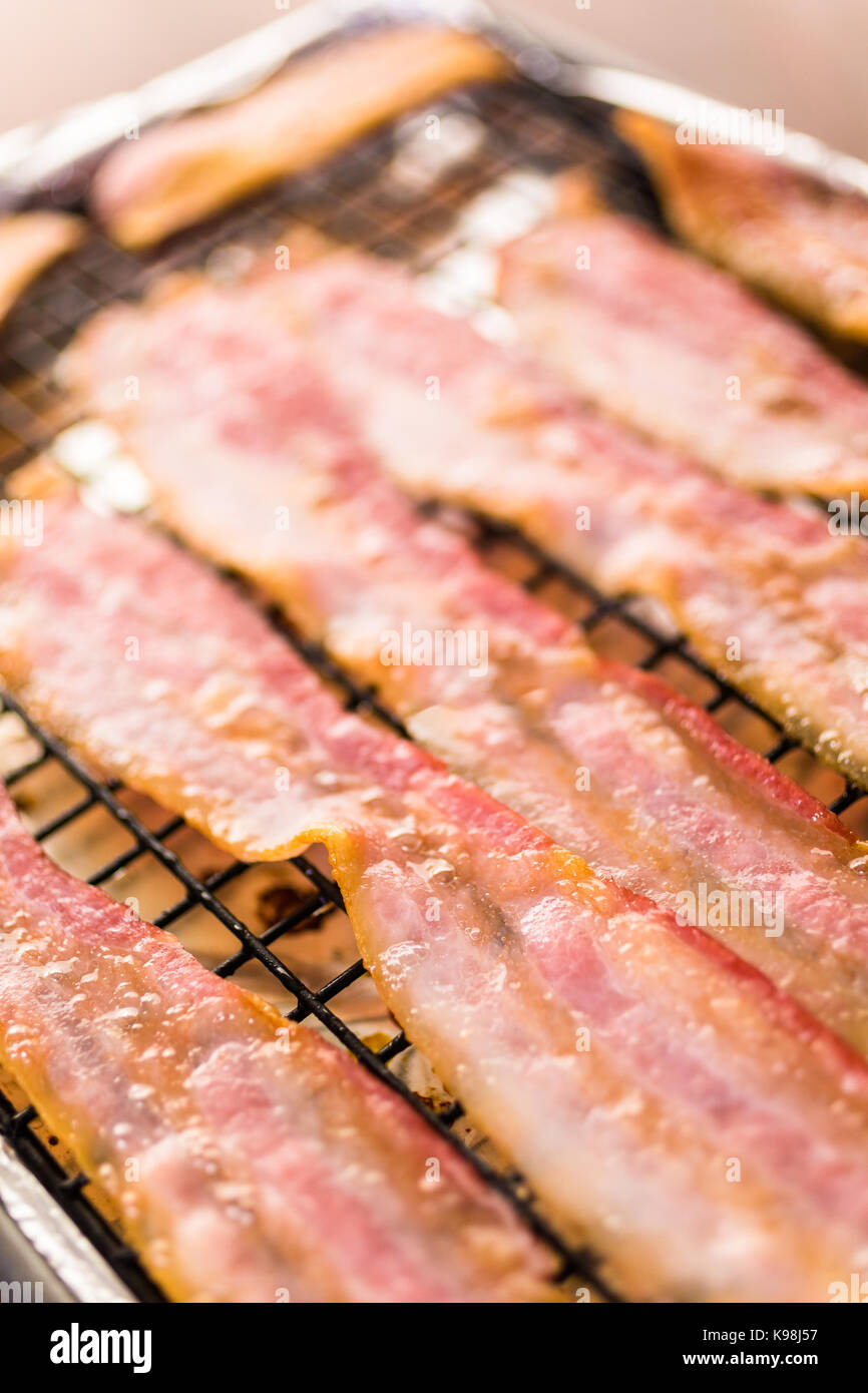 Cooked bacon strips on a baking sheet Stock Photo - Alamy