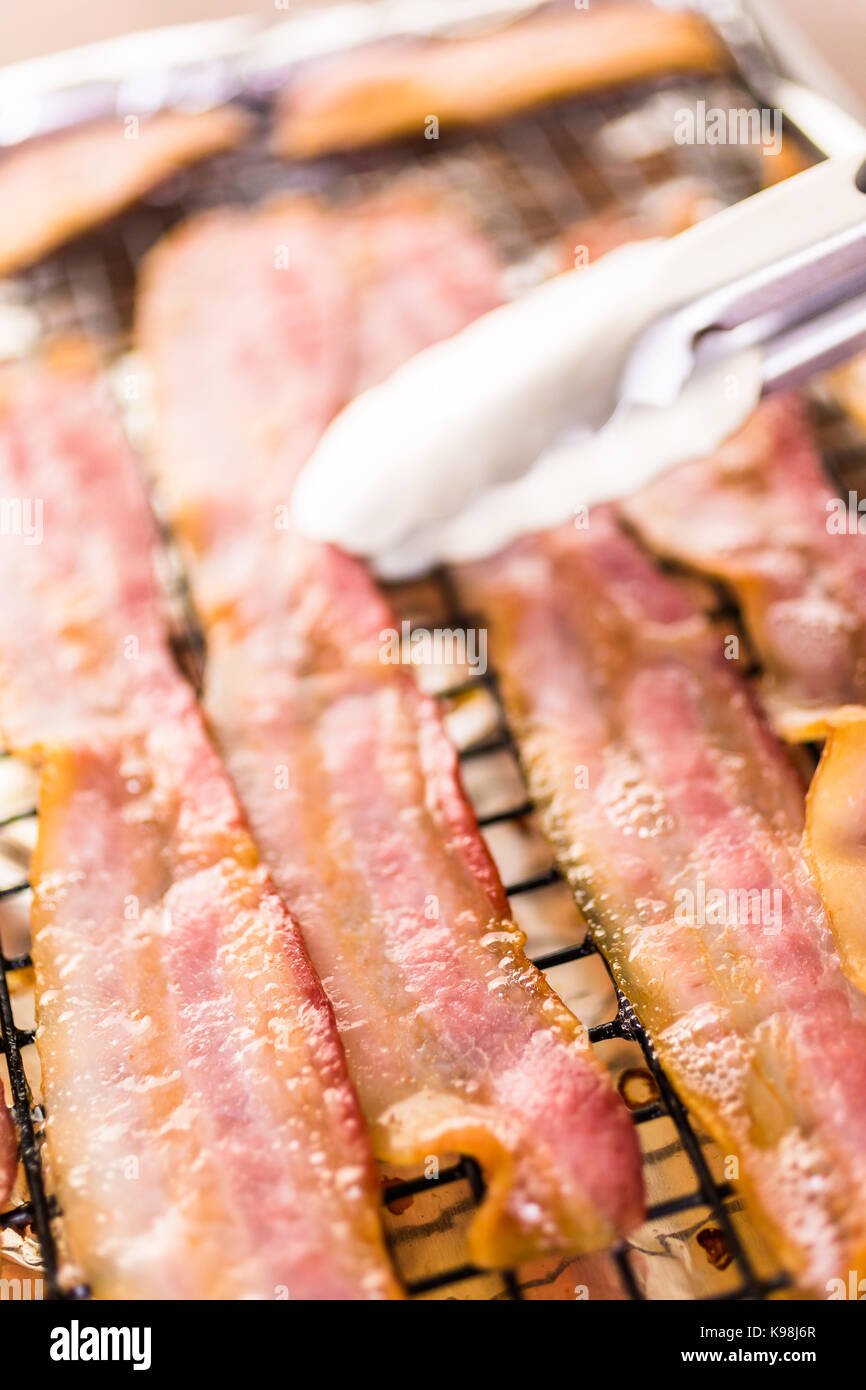 Cooked bacon strips on a baking sheet Stock Photo - Alamy