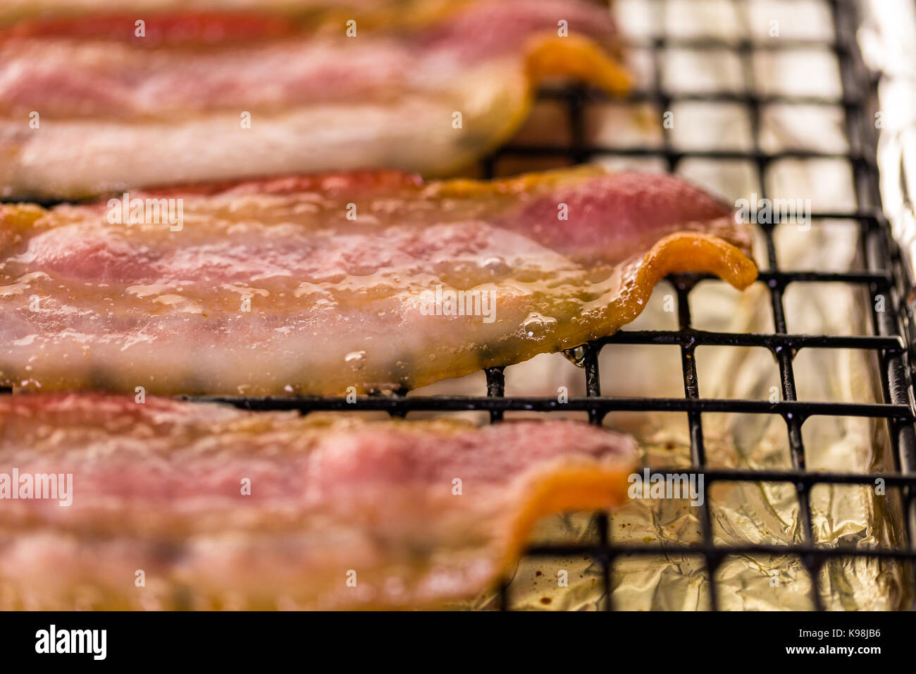 Cooked bacon strips on a baking sheet Stock Photo - Alamy