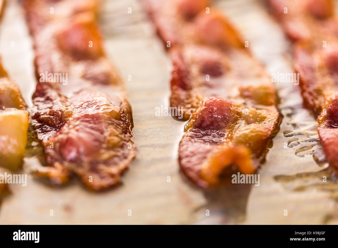 Cooked bacon strips on a baking sheet Stock Photo - Alamy