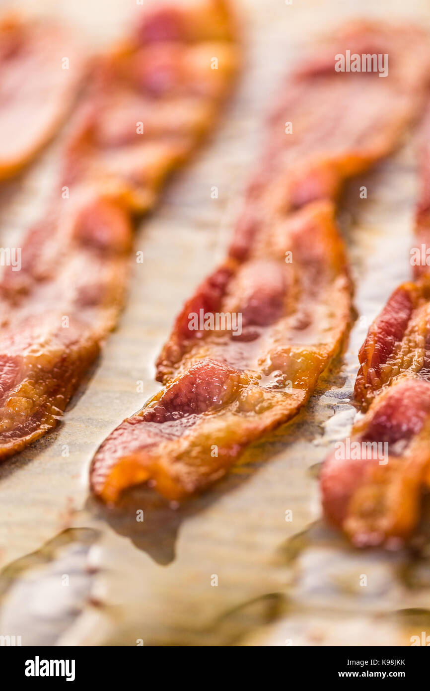 Cooked bacon strips on a baking sheet Stock Photo - Alamy